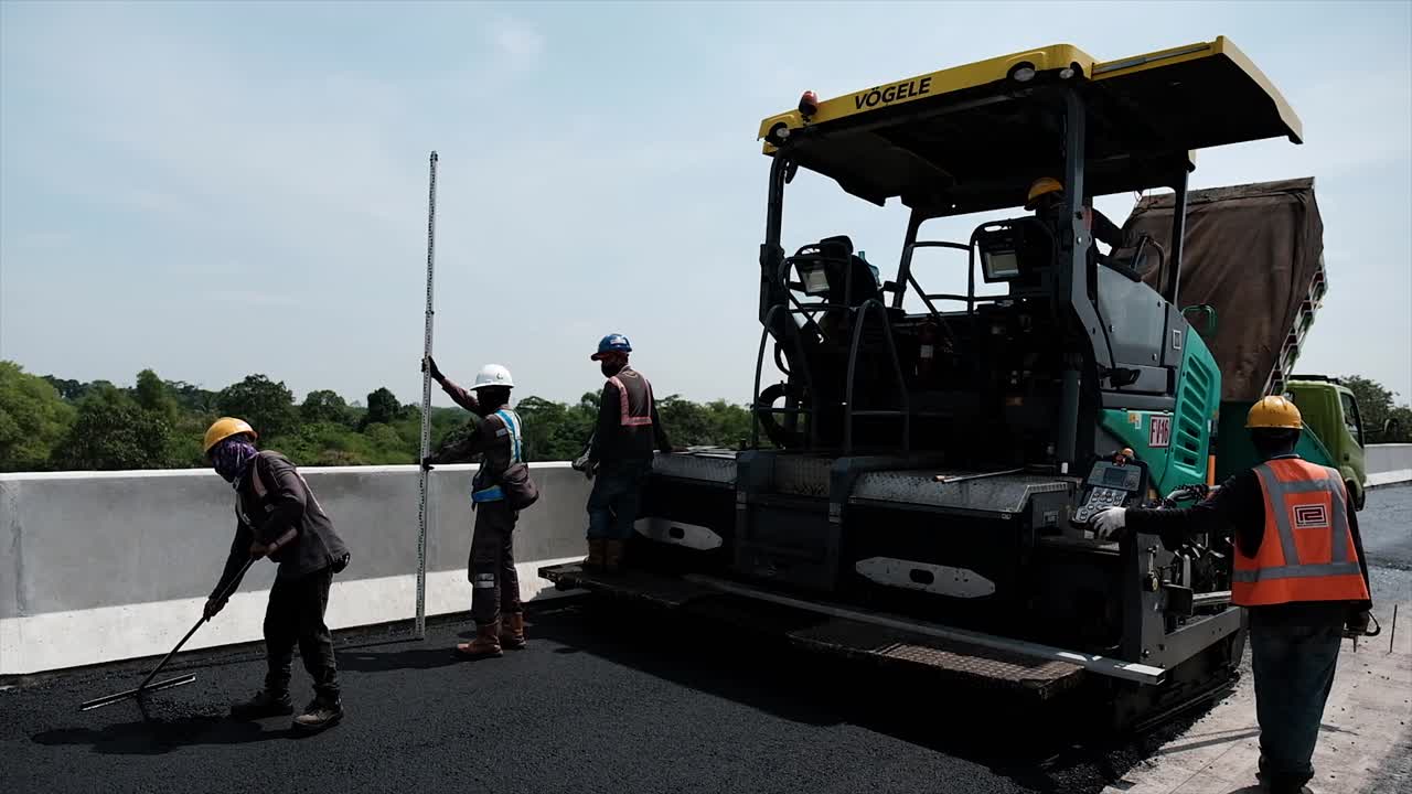 Compressing, Compacting, Leveling And Smoothing The Asphalt Road ...