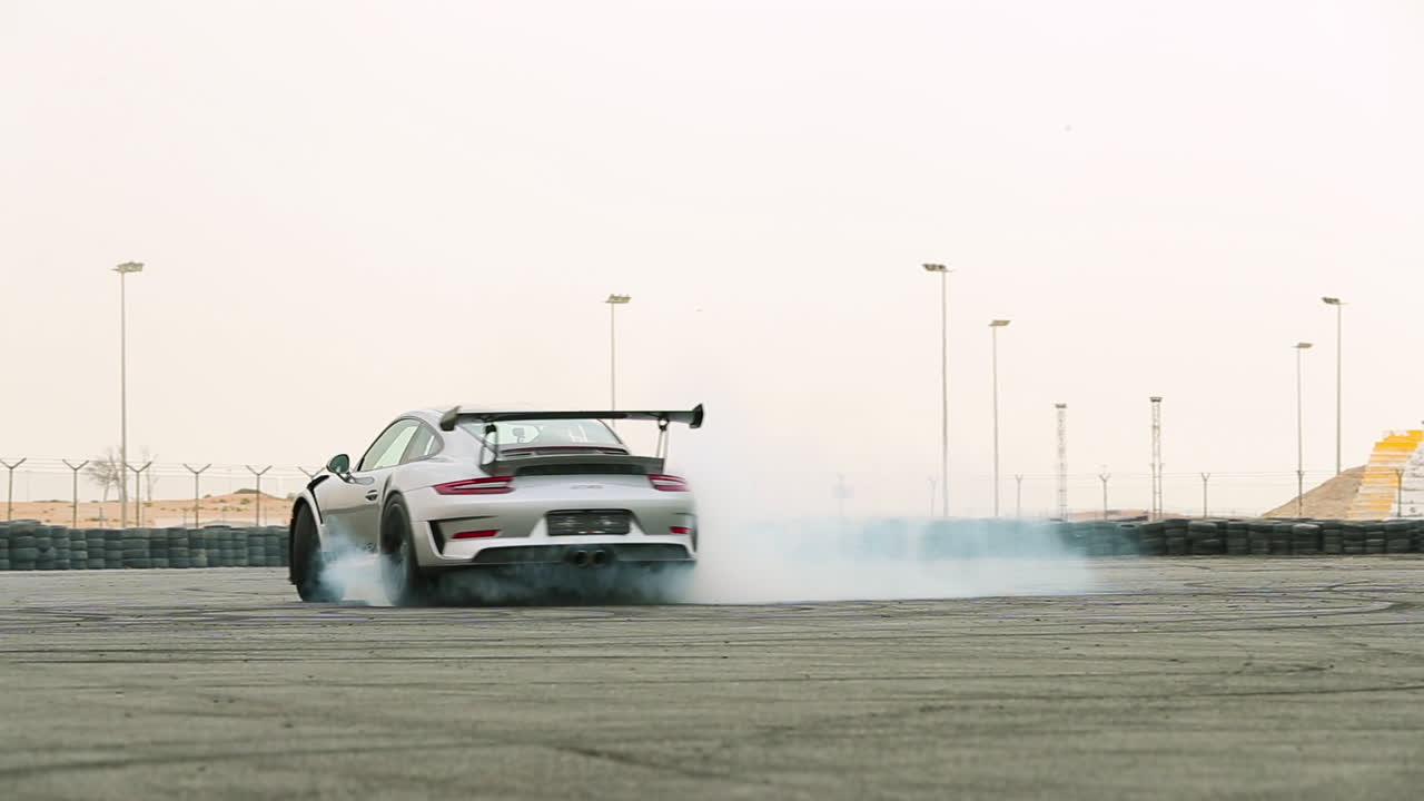 Sports Car Doing Donuts On A Track In Slow Motion With Lots Of Smoke ...