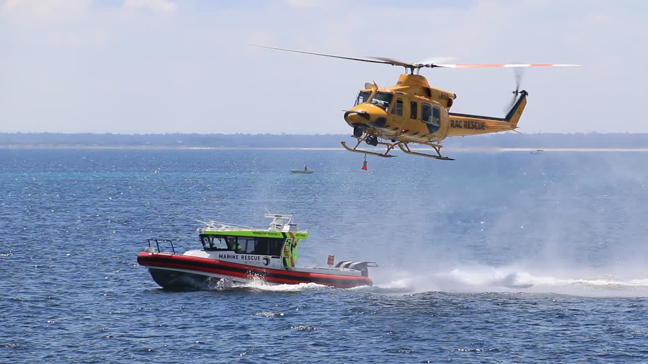 RAC Rescue Helicopter Lifting Up And Away From Marine Rescue Boat ...