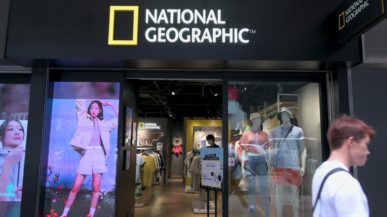 Chinese Pedestrians Walk Past The American Science, Culture, Nature ...