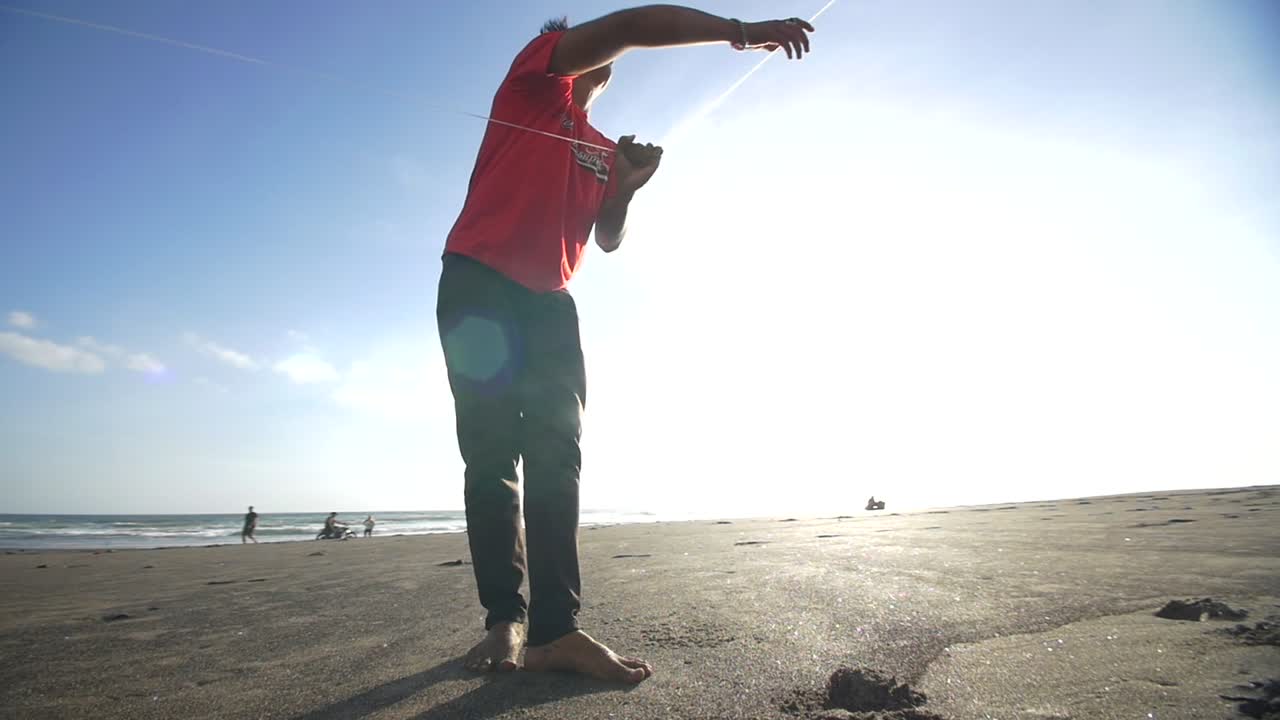 Man Pulling On A Kite String On A Beach Free Stock Video Footage ...