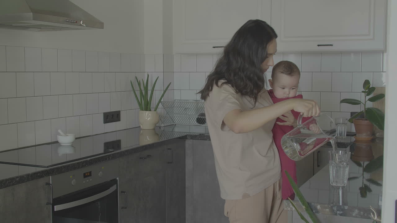 Free stock video - Mom and cute baby in kitchen copy space