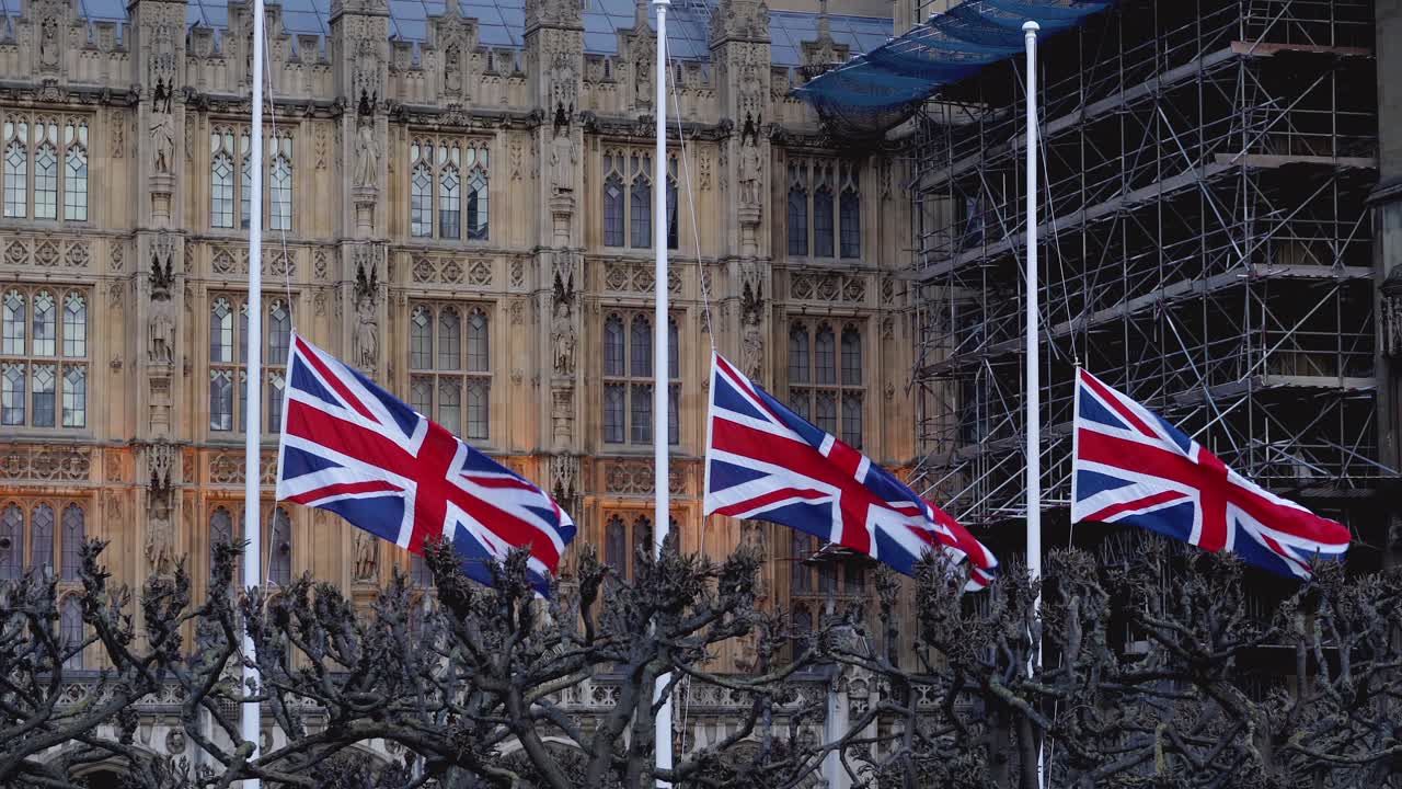 Premium stock video - Palace of westminster union jacks flying at half ...