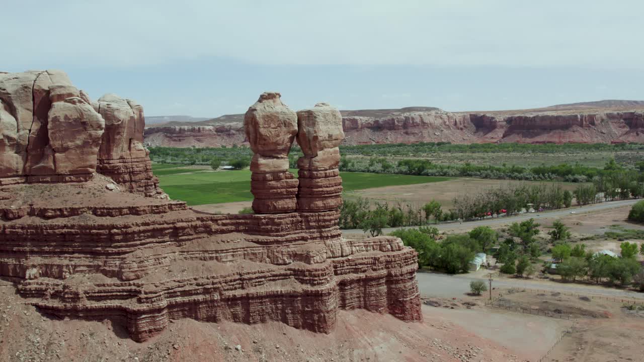 Symmetrical Rock Formations Towering Over Desert Town Of Bluff, Utah ...
