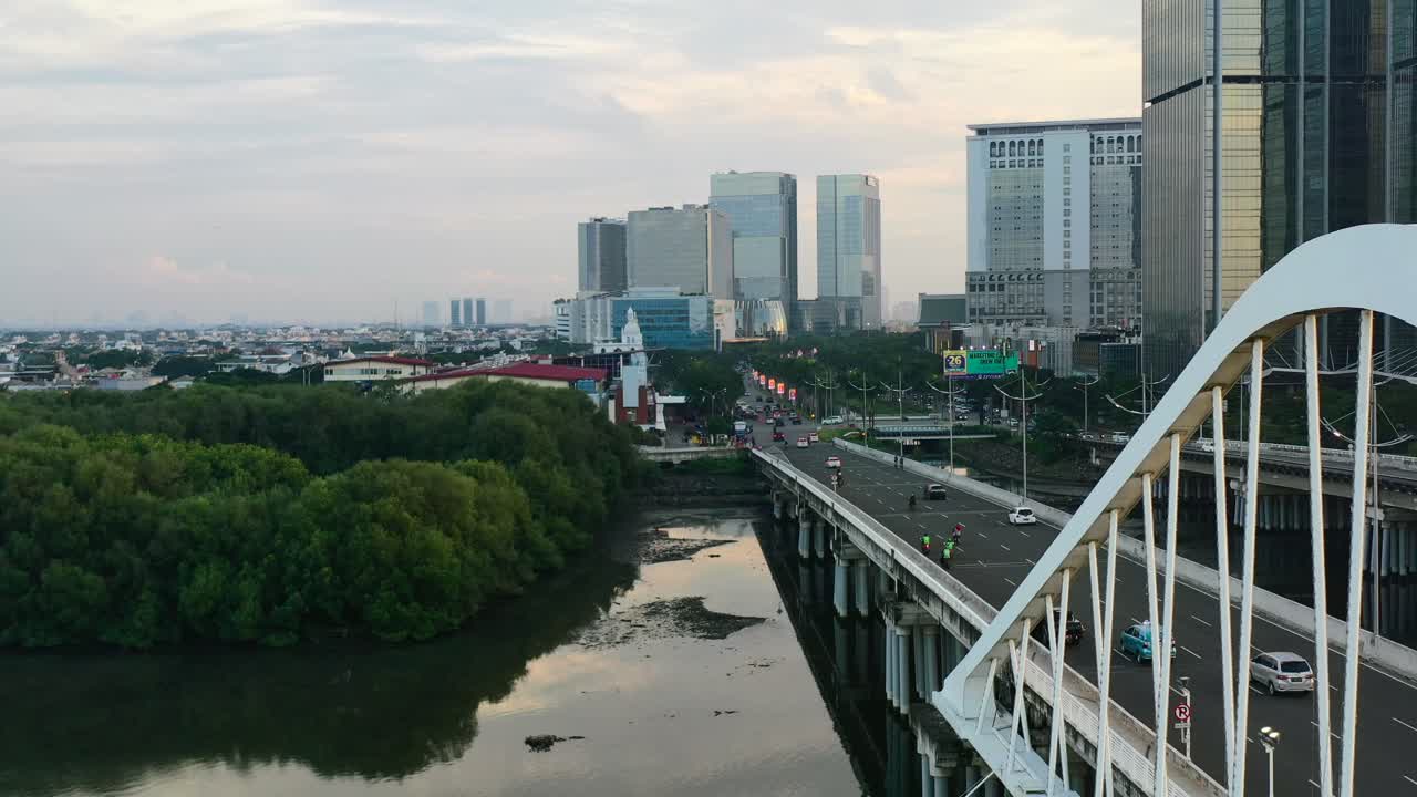 Cars And Motorbikes Driving Across Modern Bridge In PIK Jakarta At ...