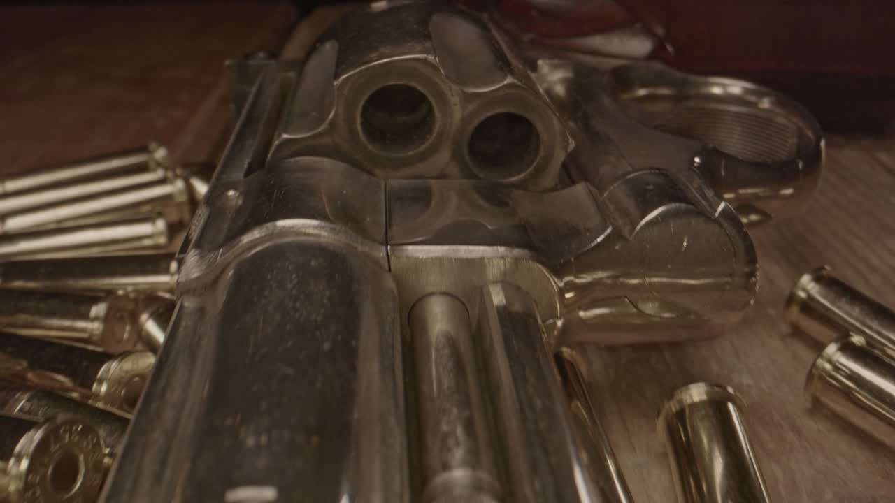 Macro Dolly Over Old Western Revolver With Empty Cilinder Surrounded By ...