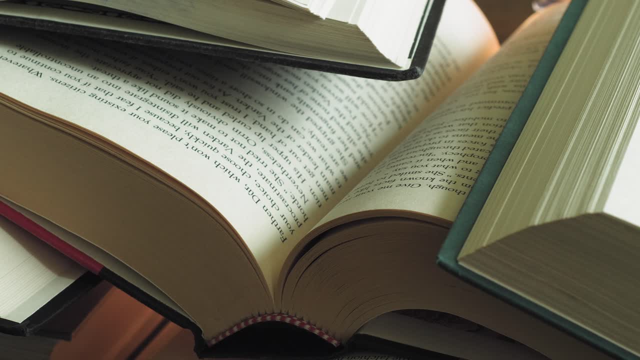 Pile Of Open Books Slider Medium Shot Right To Left Free Stock Video ...