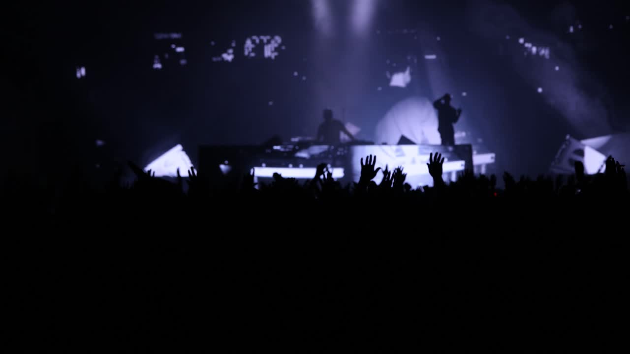 A Static Shot Of Crowd Raising Their Hands And Enjoying Great DJ Party ...