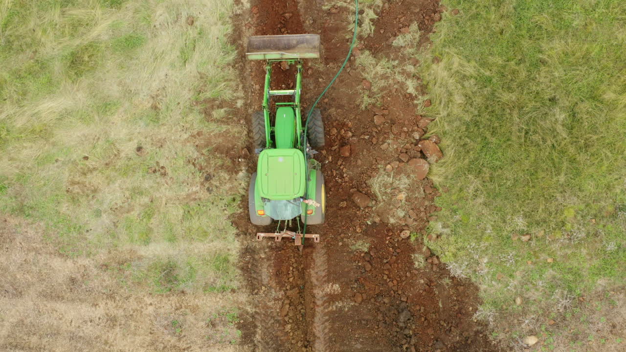 Top Down View Of Green Tractor Pipe Laying Irrigation Pipeline On Farm ...