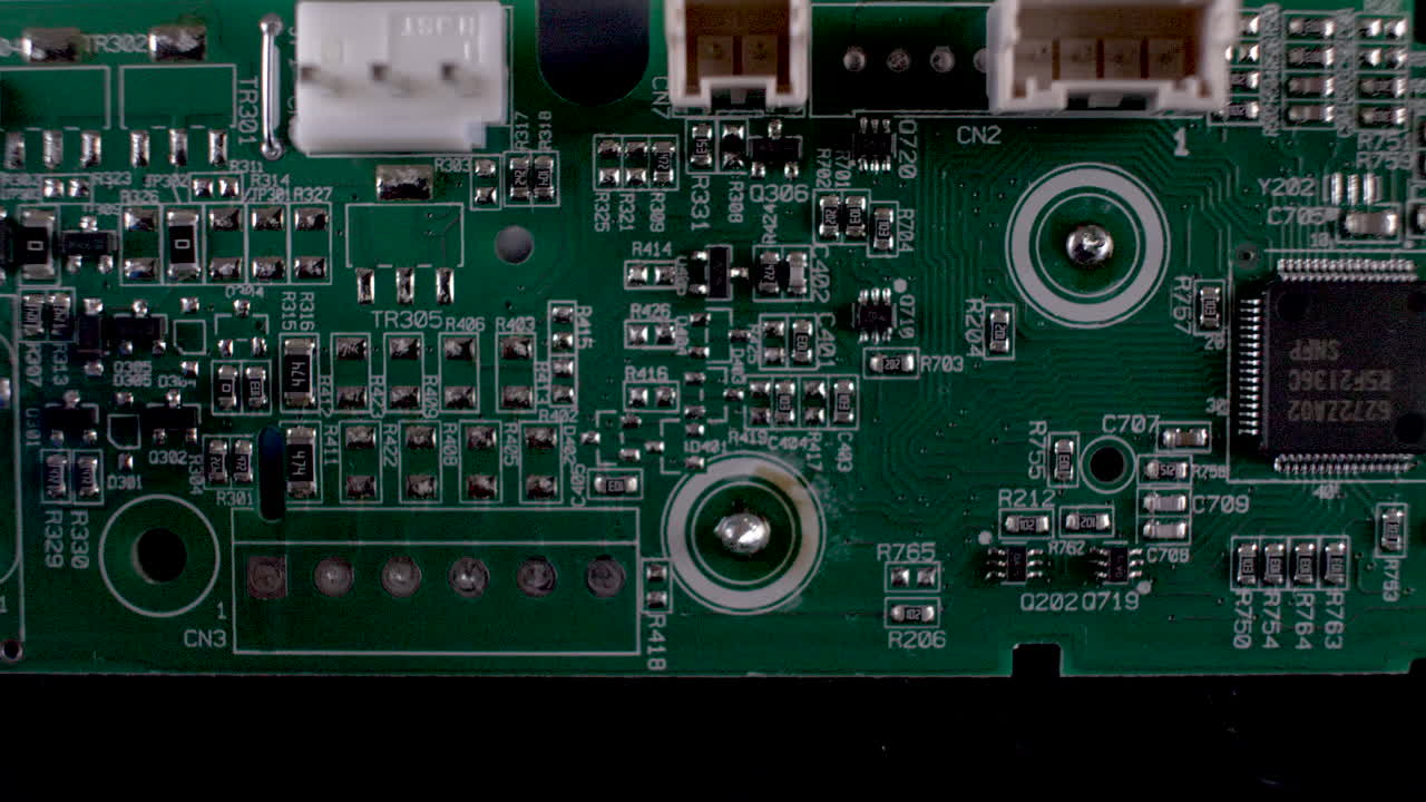 Premium stock video - Macro overhead view of complex printed circuit board