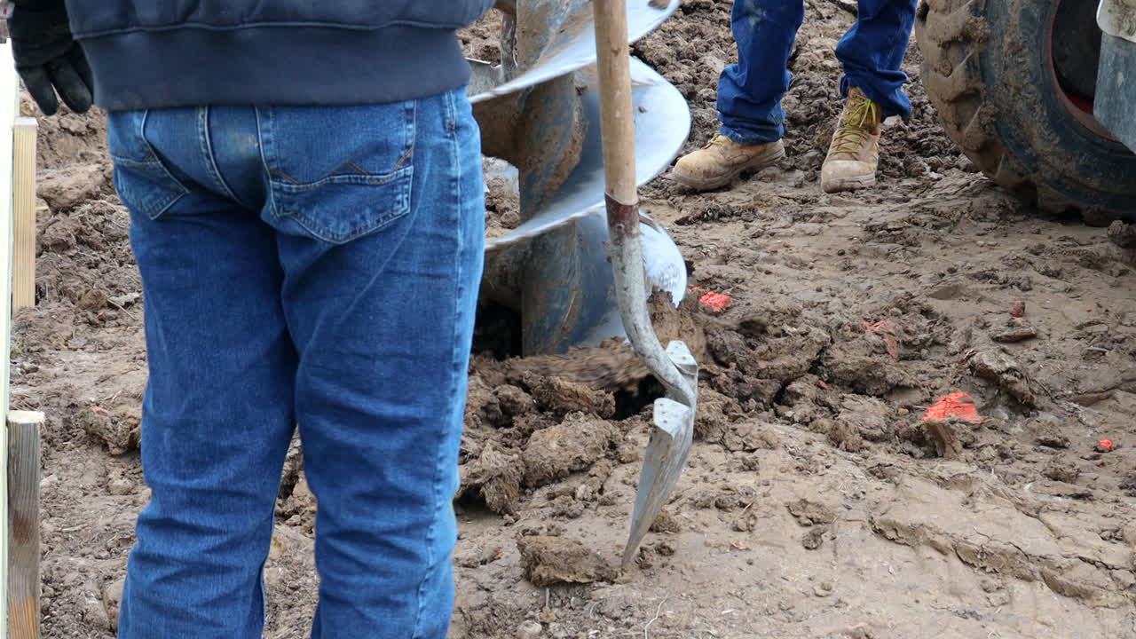 Close Up Of Hydraulic Auger Mounted On Skid Steer Loader Is Positioned ...