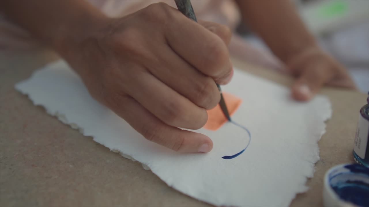 Premium stock video - Slow motion close-up shot of hand with a painting ...