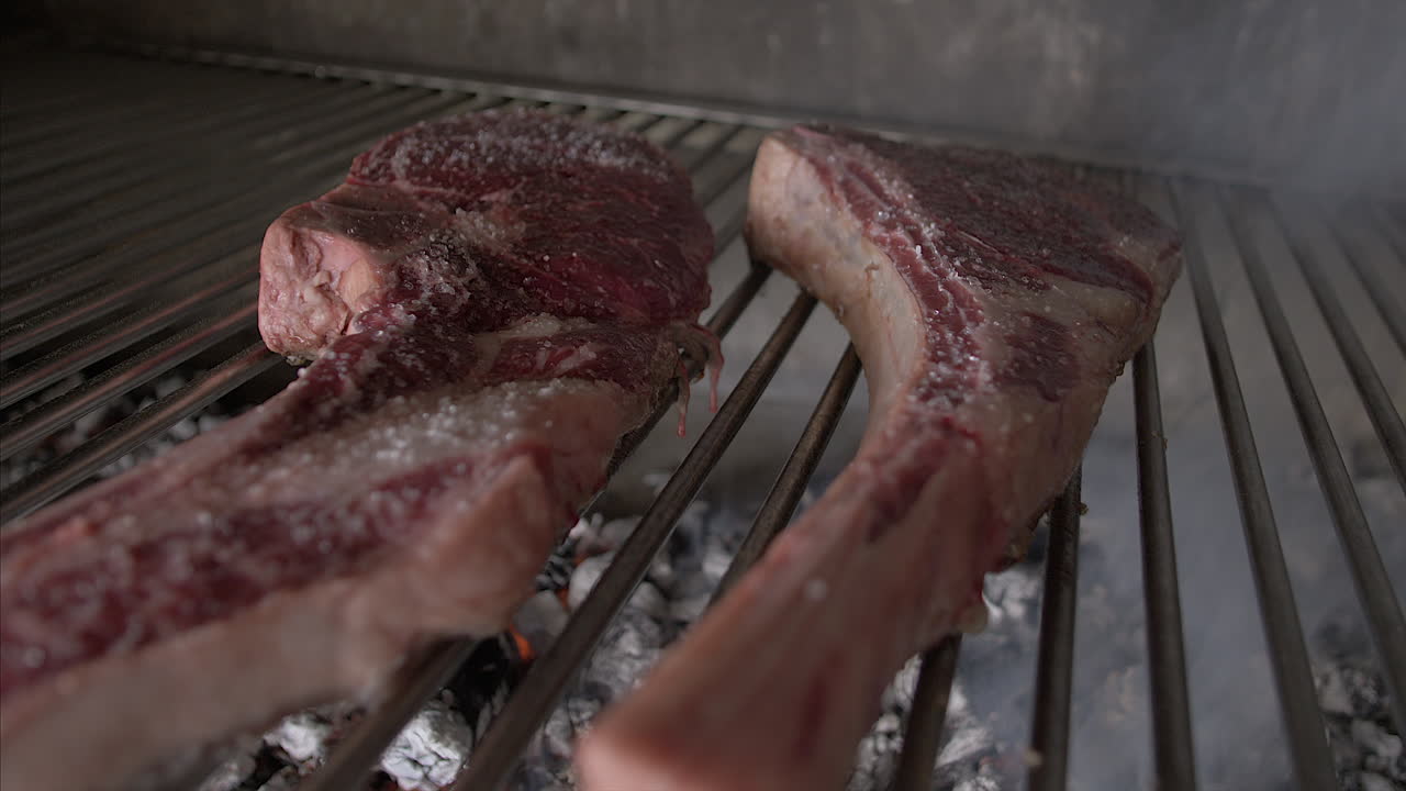 Close Up Of A Tomahawk Beef On The Grill, With The Wood Burning On The ...
