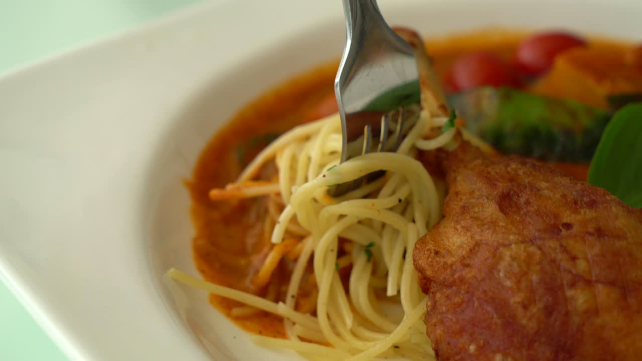Premium stock video - Spicy spaghetti with fried duck on plate