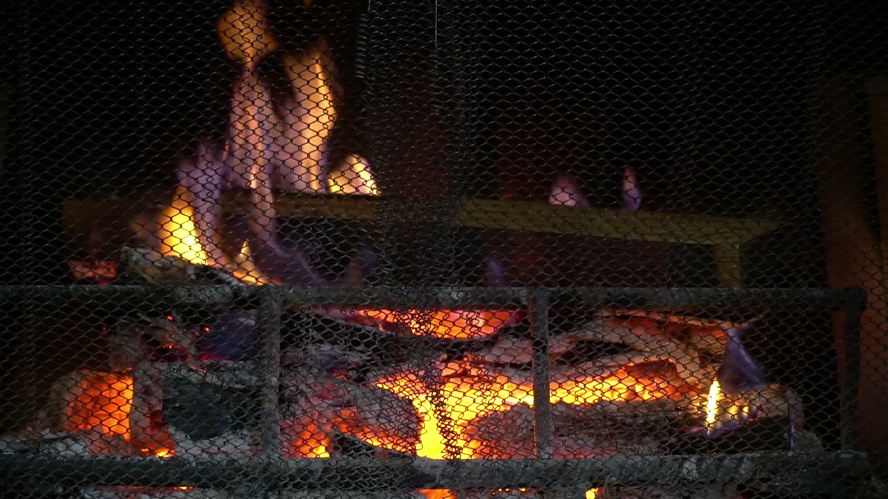 Slow Burning Logs In A Vintage Brick Fireplace With Screen In Front Of ...