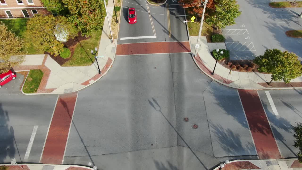 Aerial Tilt Up Of Intersection Reveals Large Brick Building, Tree-lined ...
