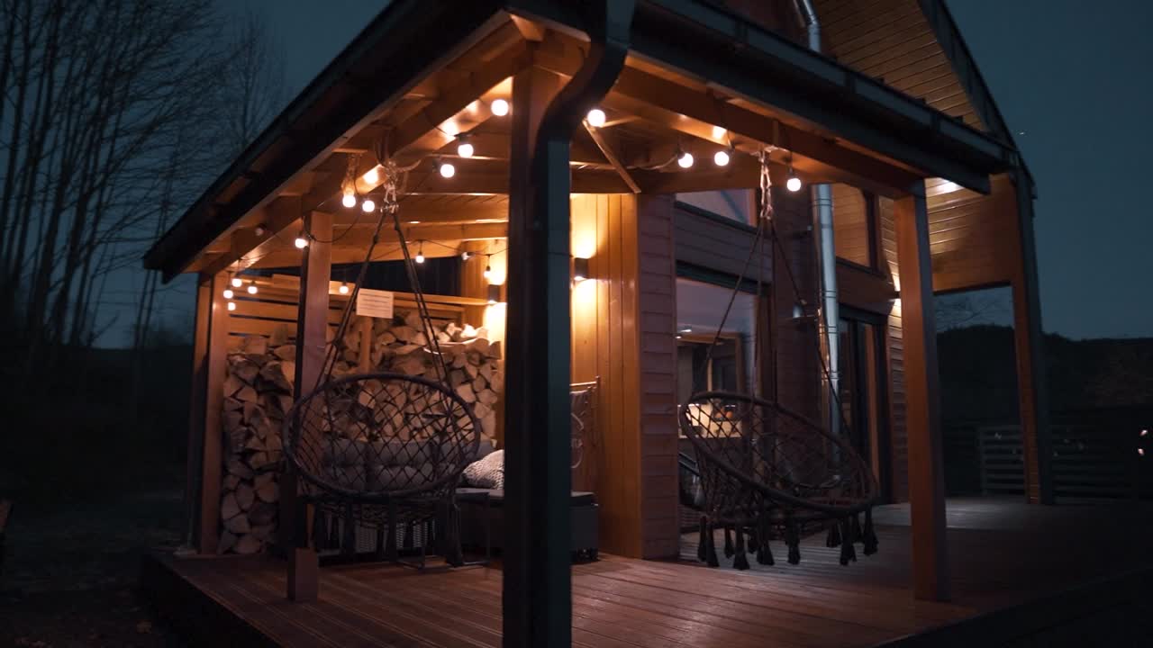 Premium stock video - Illuminated cozy cabin at night