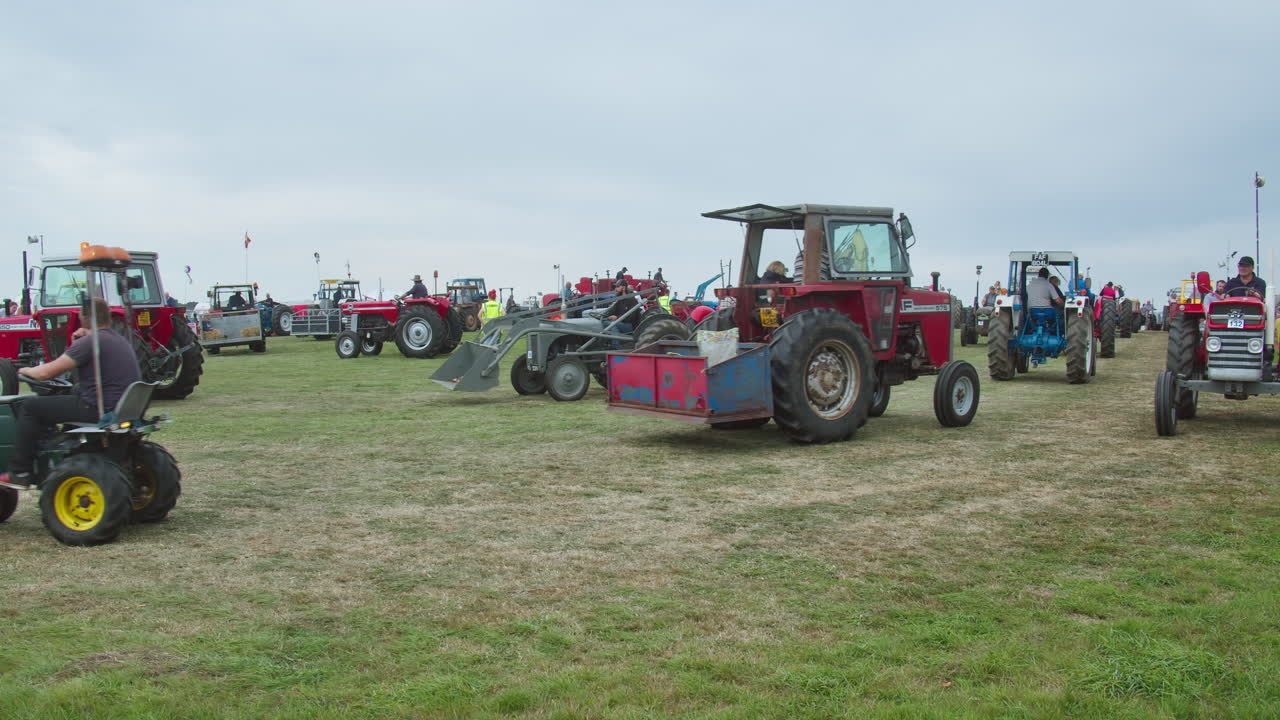 Various Vintage Agricultural Tractors Driving Around At The Field ...