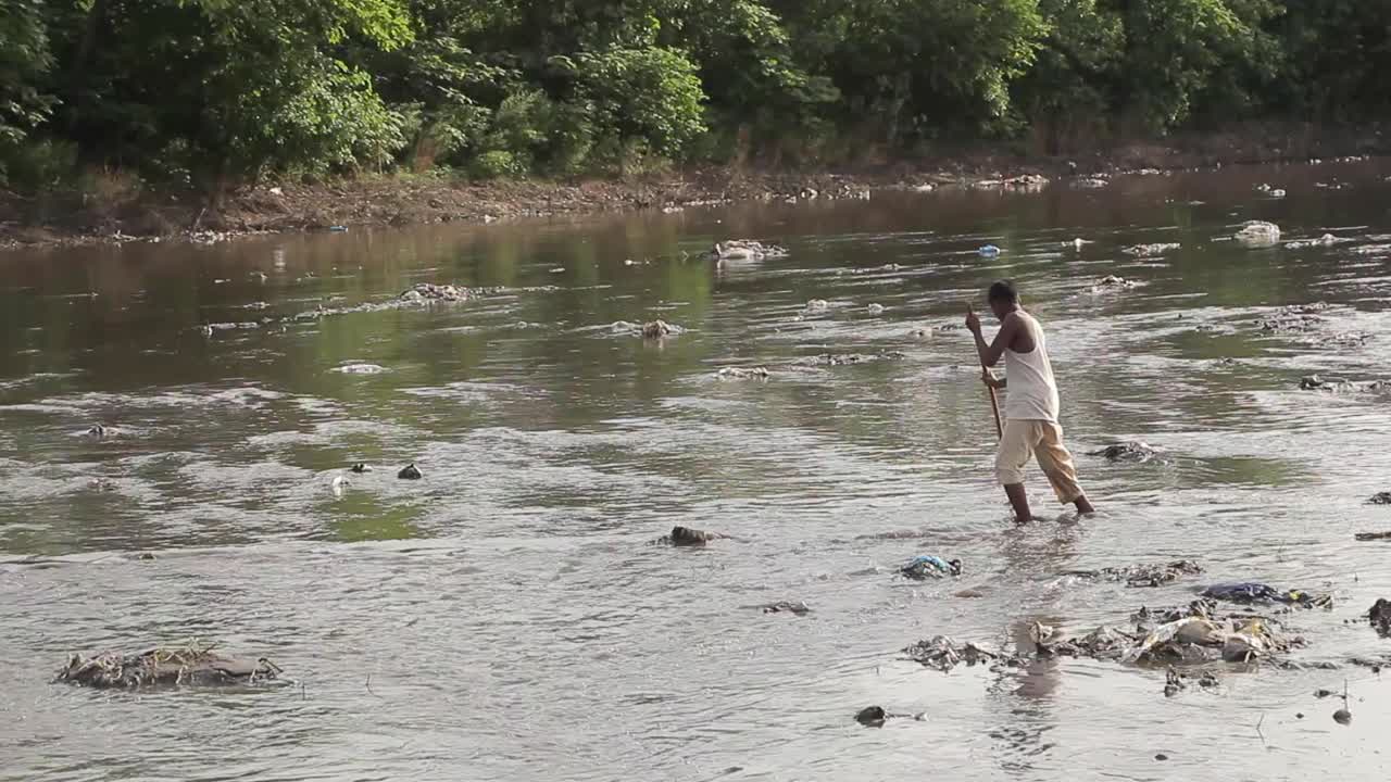 A Boy Walks Across A River In Pakistan, Dumped With Toxic Trash In ...
