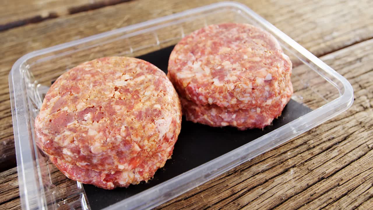 Premium stock video - Meat patty in plastic container