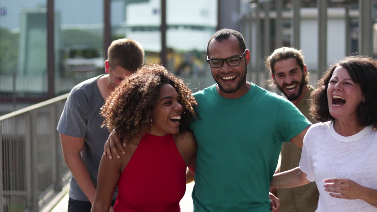 Happy friends walking and laughing outdoor | Premium Stock Video Footage