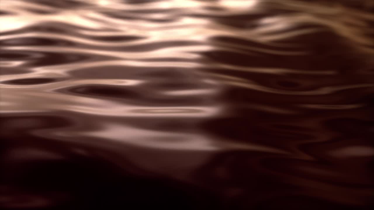 The surface of liquid chocolate. Melted milk chocolate in motion ...