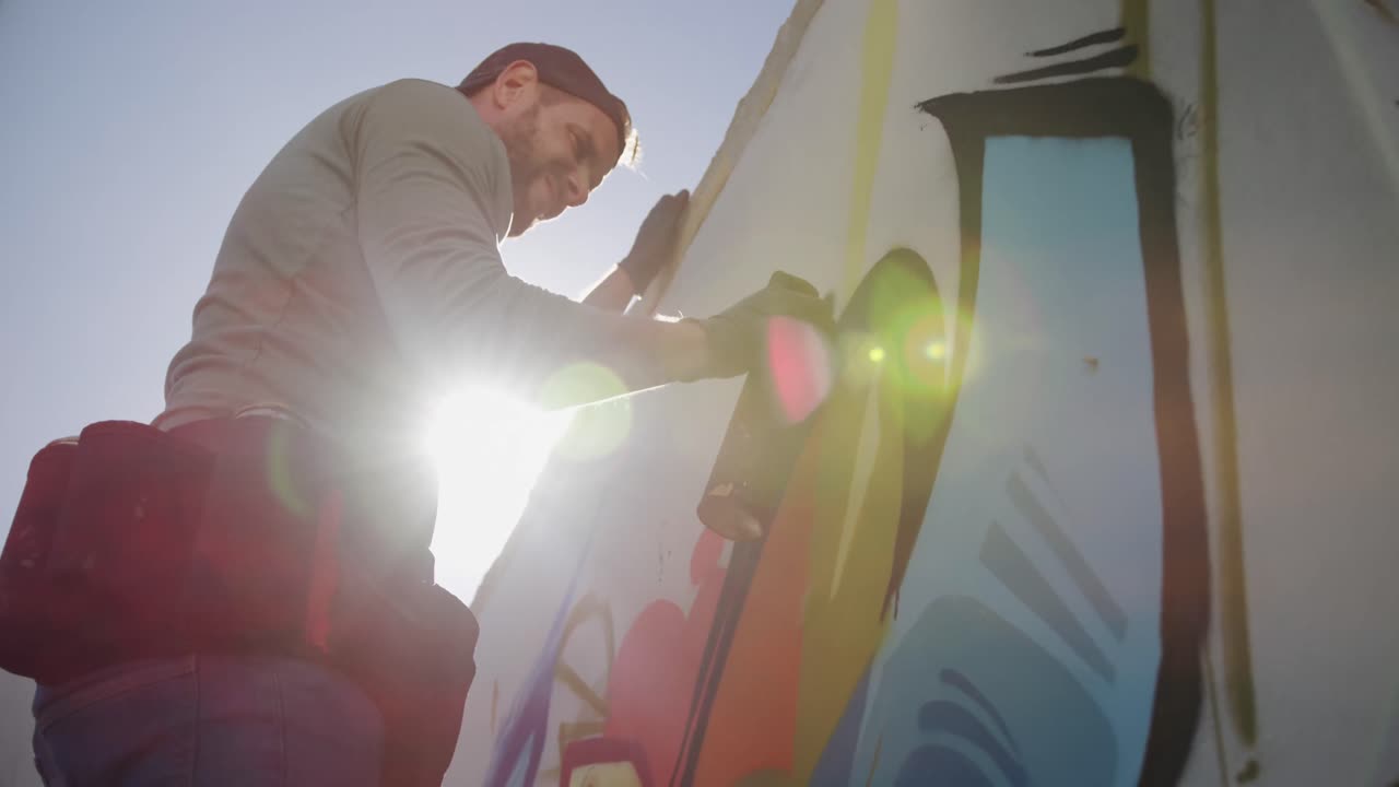 Premium stock video - Graffiti artist painting with aerosol spray 4k