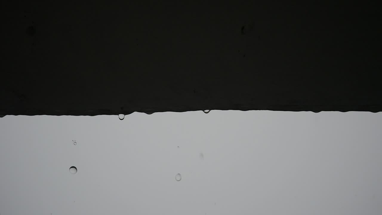 rain drops falling from ledge in perfectly half in composition | freepik