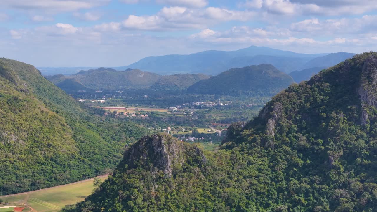 High altitude drone flight reveals a lush golf course nestled between ...