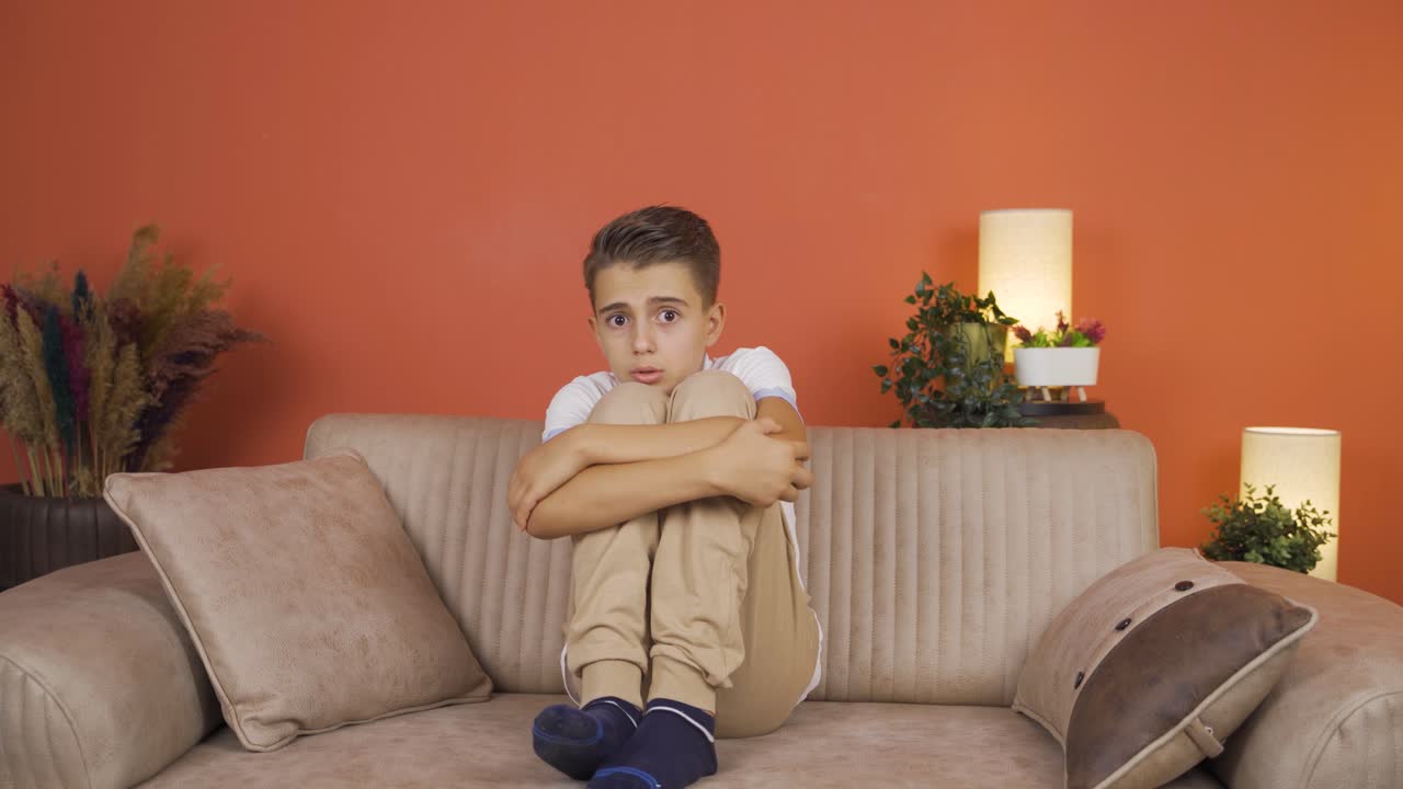 Premium stock video - Boy afraid alone at home.