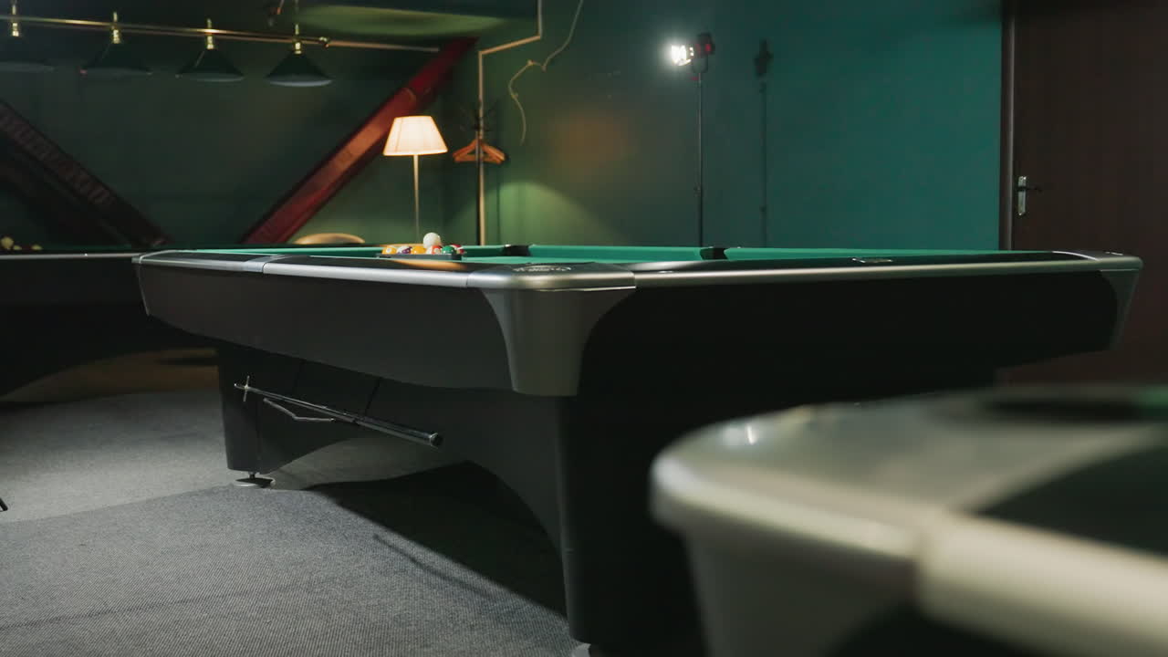 Capture of green pool tables in billiard room, with colorful billiard ...