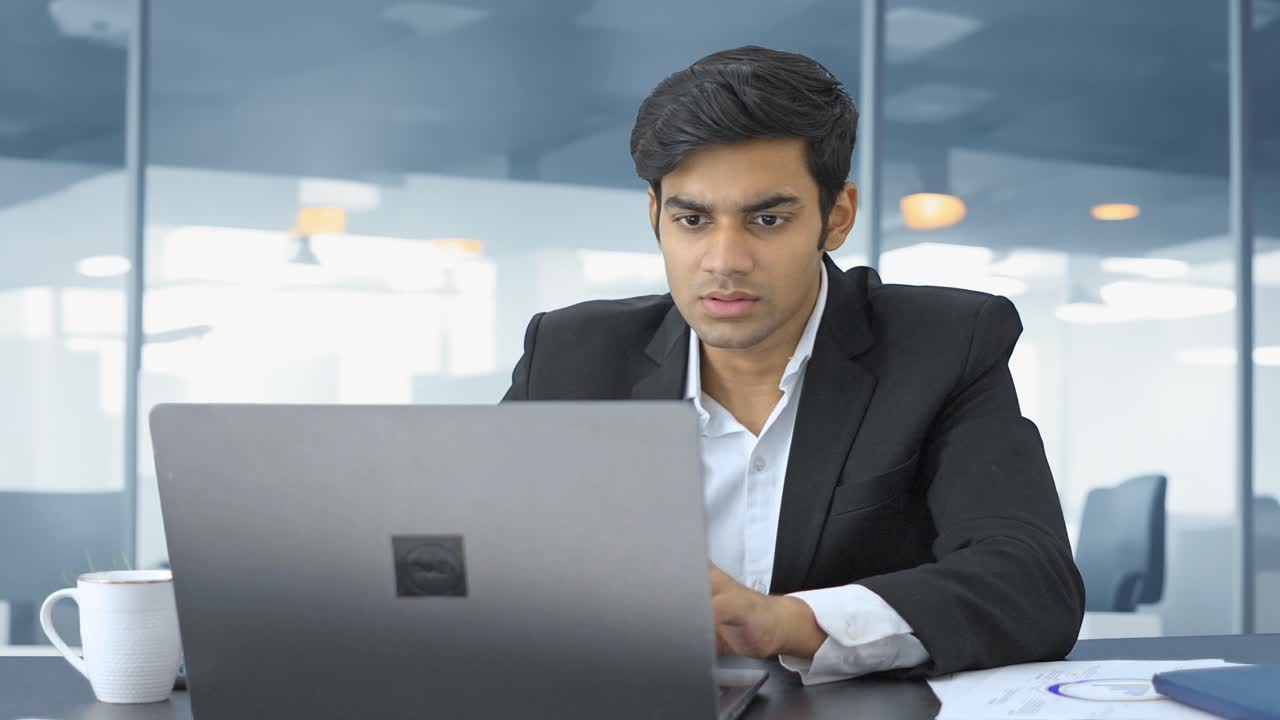 Premium stock video - Focused indian manager working in office