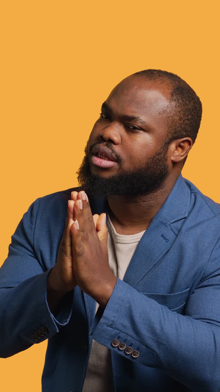 Vertical video Man putting hands together in begging gesture, making ...
