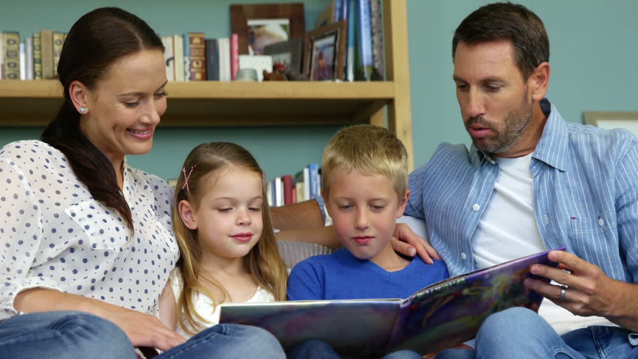 Premium stock video - Parents reading a story to their children