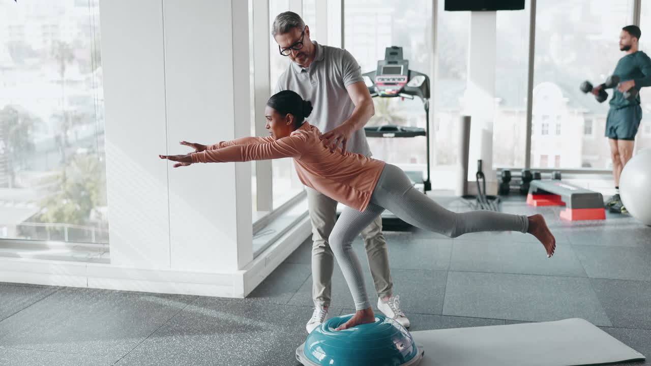Premium stock video - Coach, balance ball and woman training for health