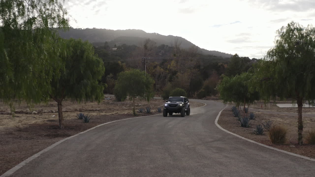 Premium stock video - Aerial view of suv jeep on an isolated curvy ...