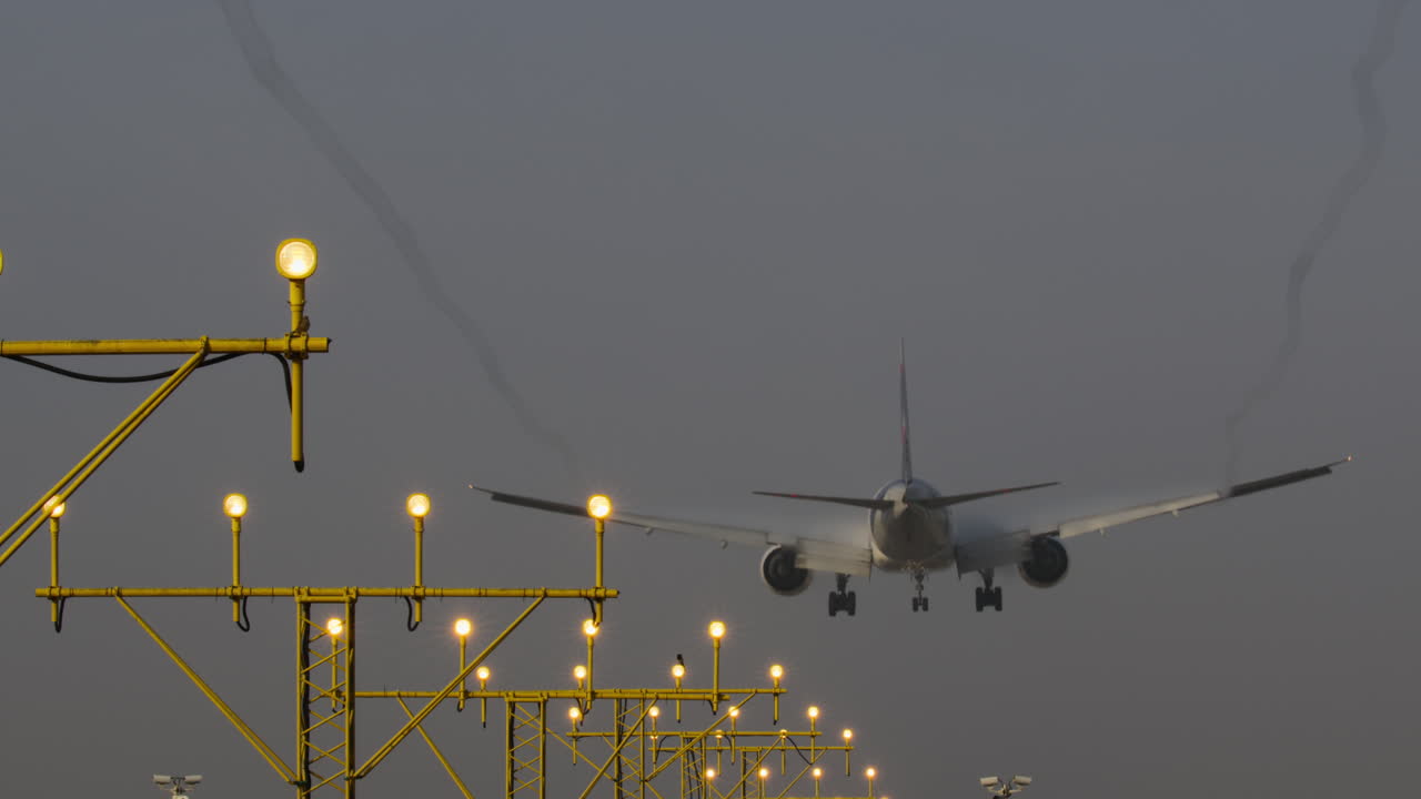 Airplane landing on a runway in fog Premium Stock Video Footage