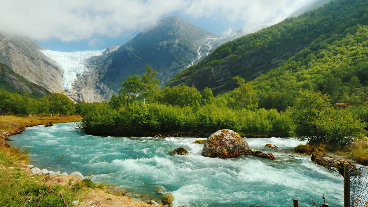 Premium stock video - Briksdal glacier with a mountain river in the ...