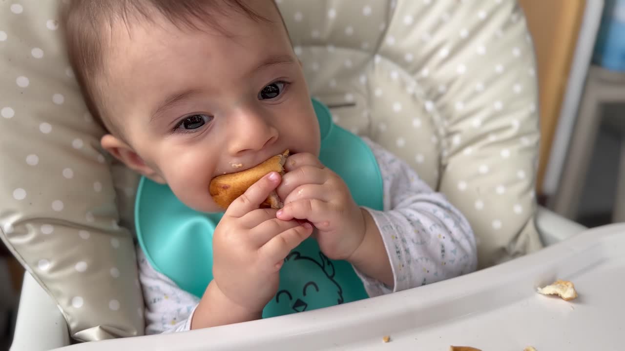 Premium stock video - Hungry baby eating bread at lunch time ...