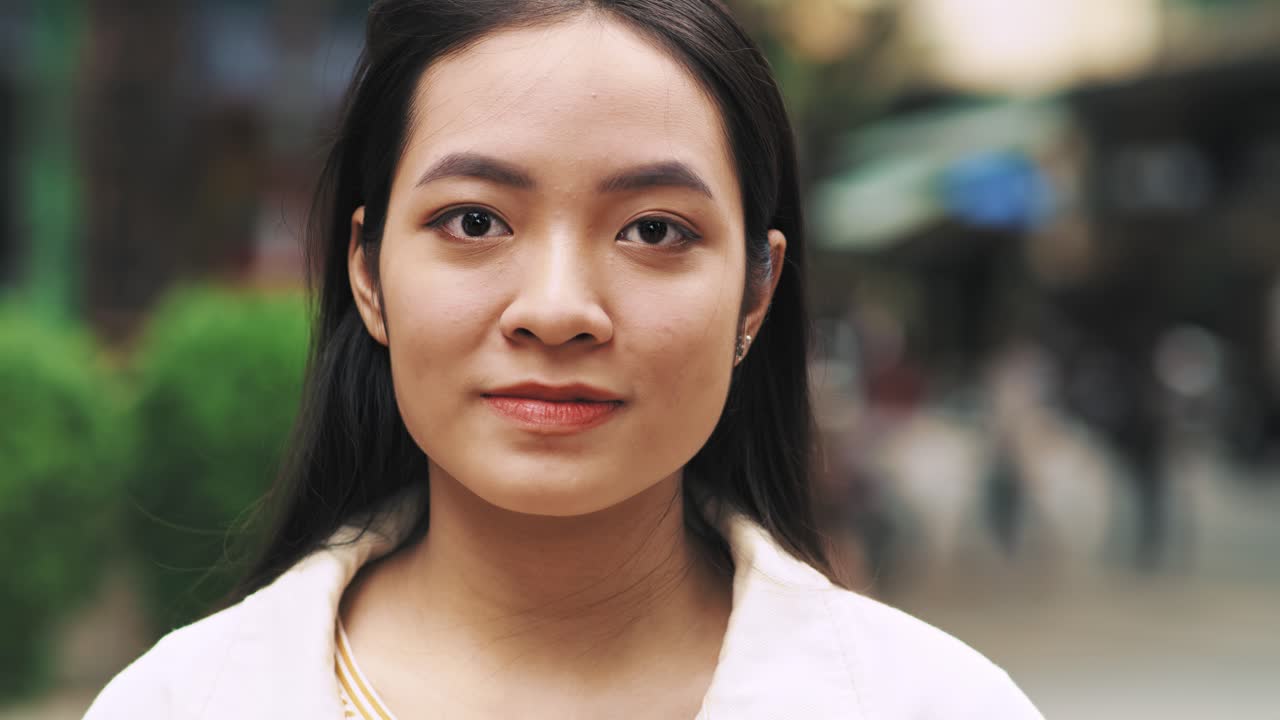 Premium stock video - Handheld view of smiling vietnamese woman