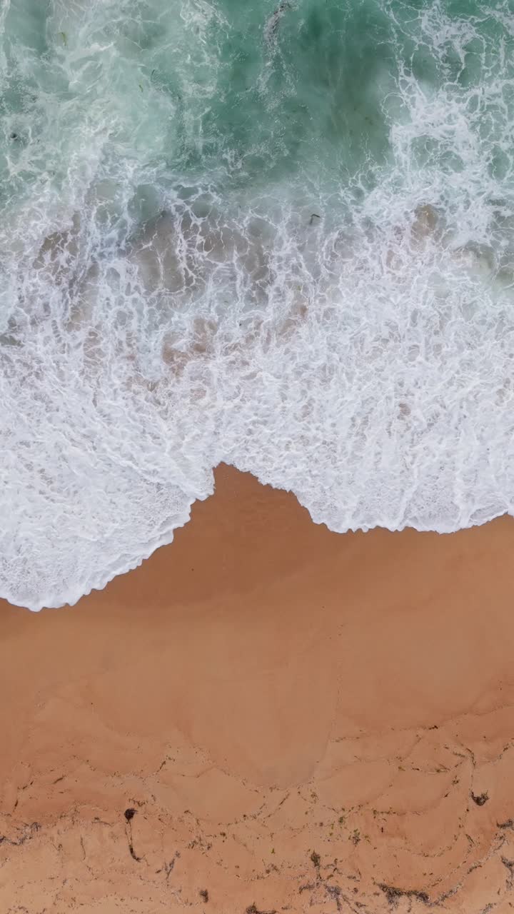Aerial footage from directly above traces the movement of waves as they ...