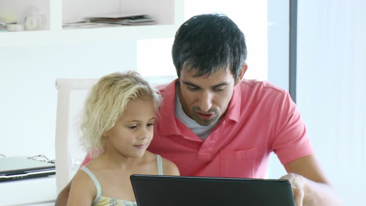 Premium stock video - Father and daughter using a laptop. computer ...