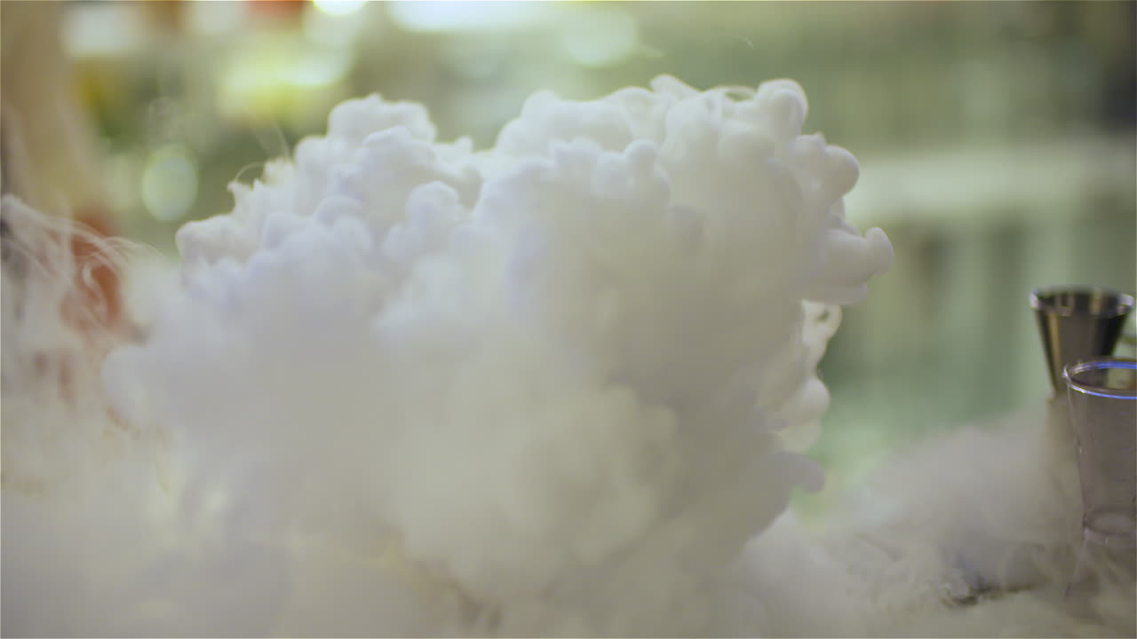 Premium stock video - Bartender preparing dry ice drink at club 2