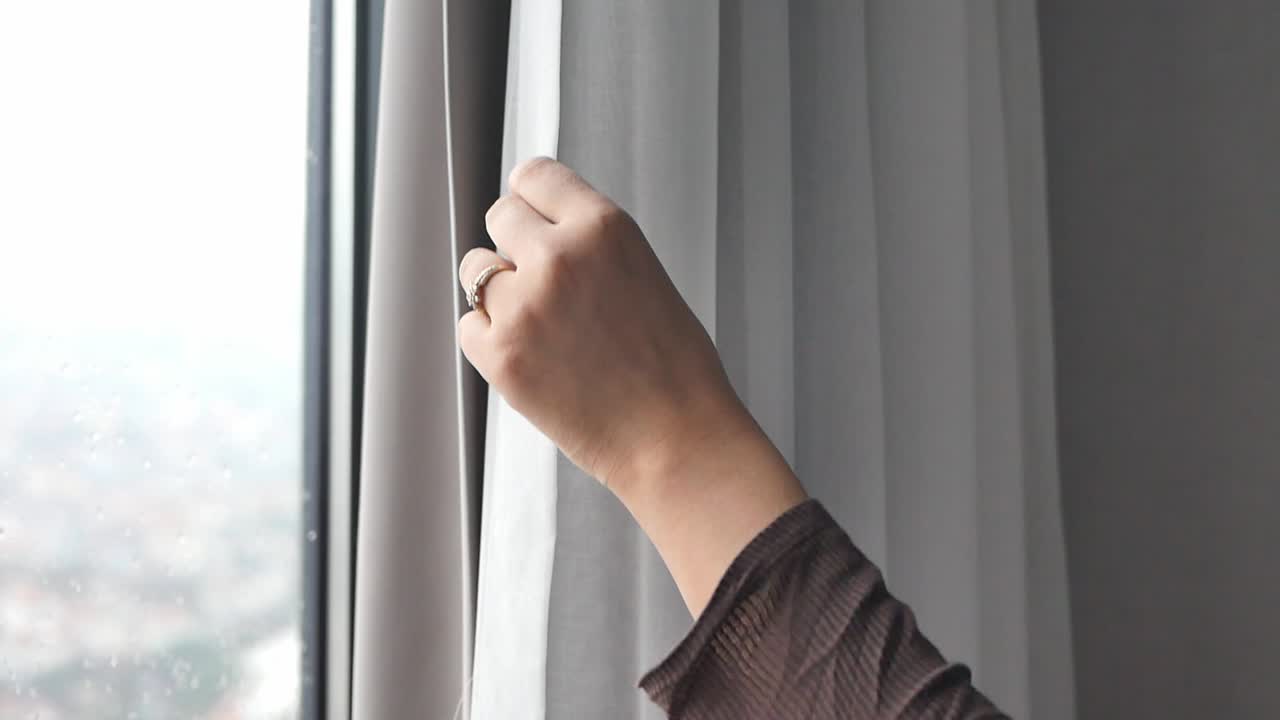 Person opening a window curtain Premium Stock Video Footage