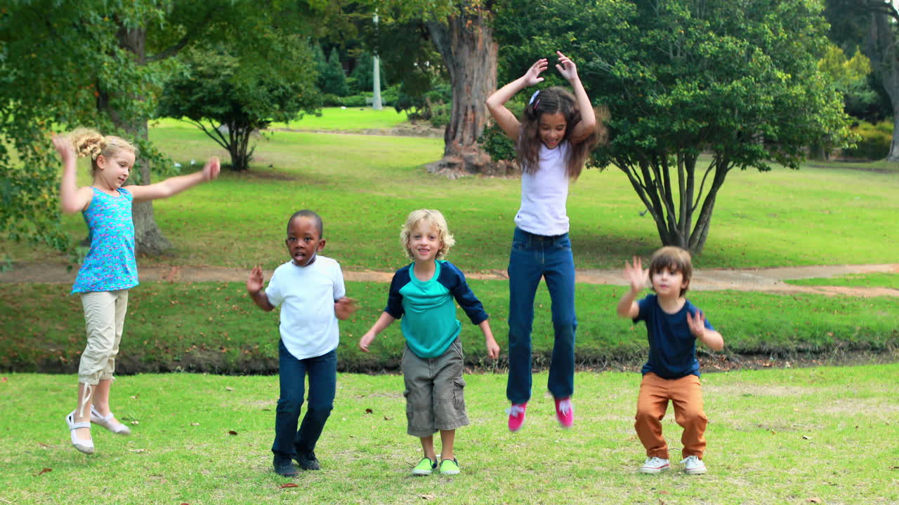 Premium stock video - Happy children jumping together in park