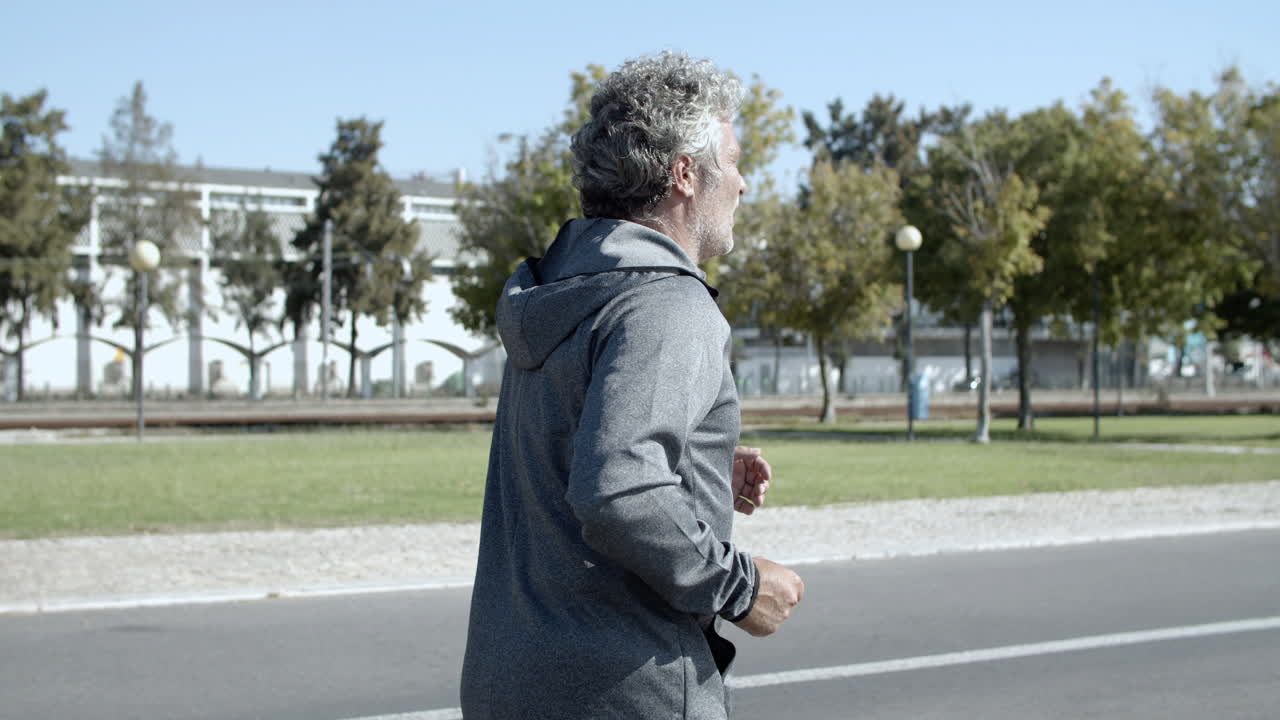 Free stock video - Elder male runner jogging outside