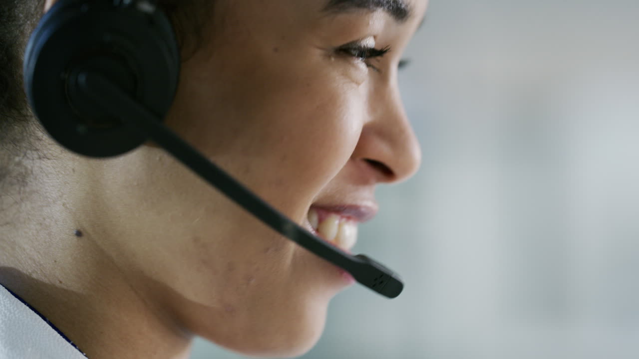 Premium stock video - A young woman using a headset in an office