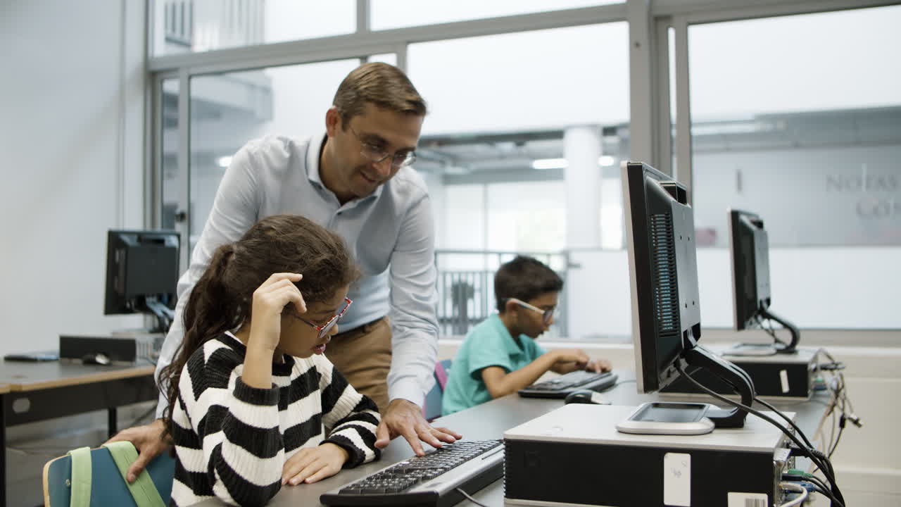 Free stock video - Focused schoolgirl looking teacher typing on ...
