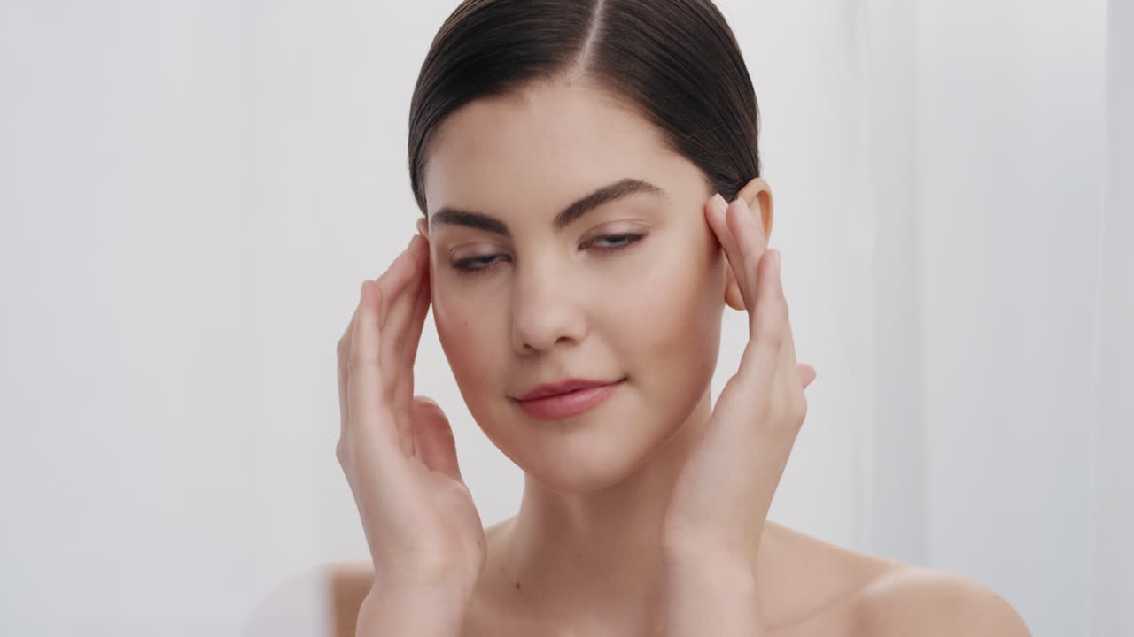 Portrait beautiful young woman gently touching skin with hands ...