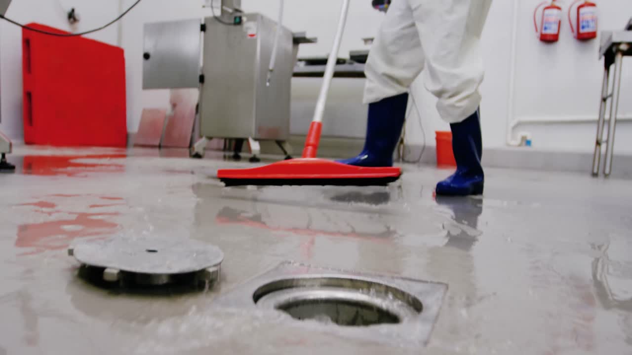 Butcher cleaning floor | Premium Stock Video Footage